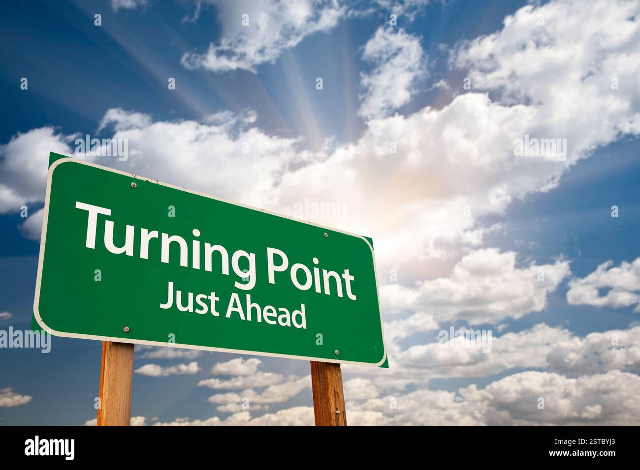 Turning Point Green Road Sign and Clouds Stock Photo - Alamy
