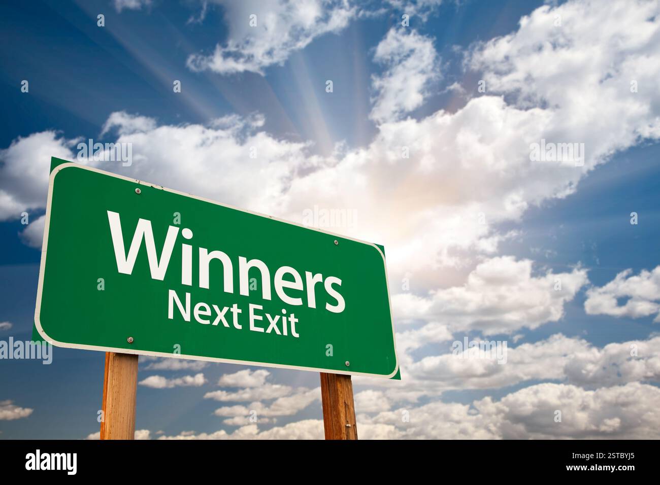 Winners Green Road Sign and Clouds Stock Photo - Alamy