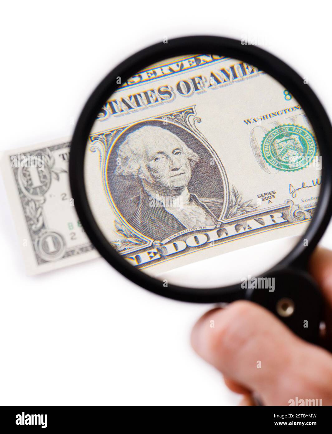 Counterfeit dollar on magnifier photographed on a white background ...