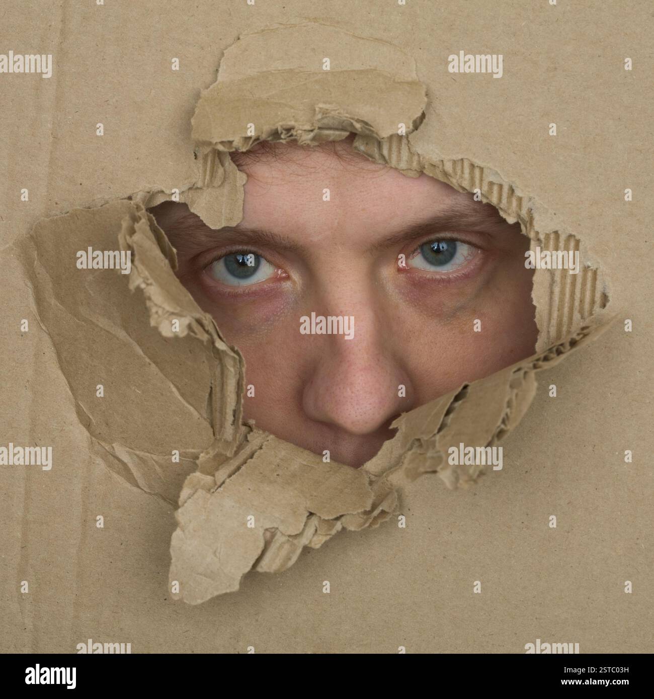 Face in hole hi-res stock photography and images - Alamy