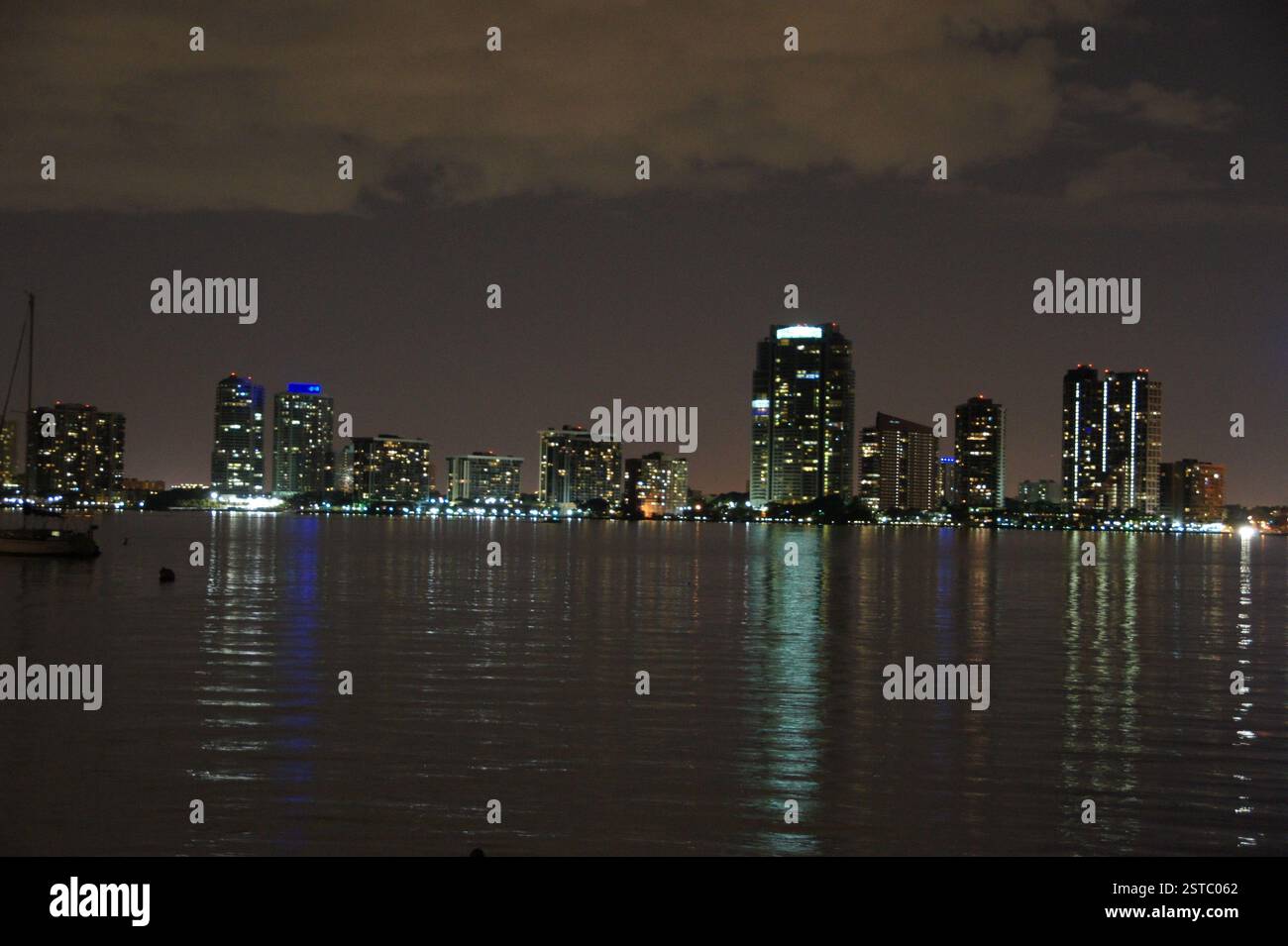 Miami skyline at night, tall buildings illuminated in various colors ...