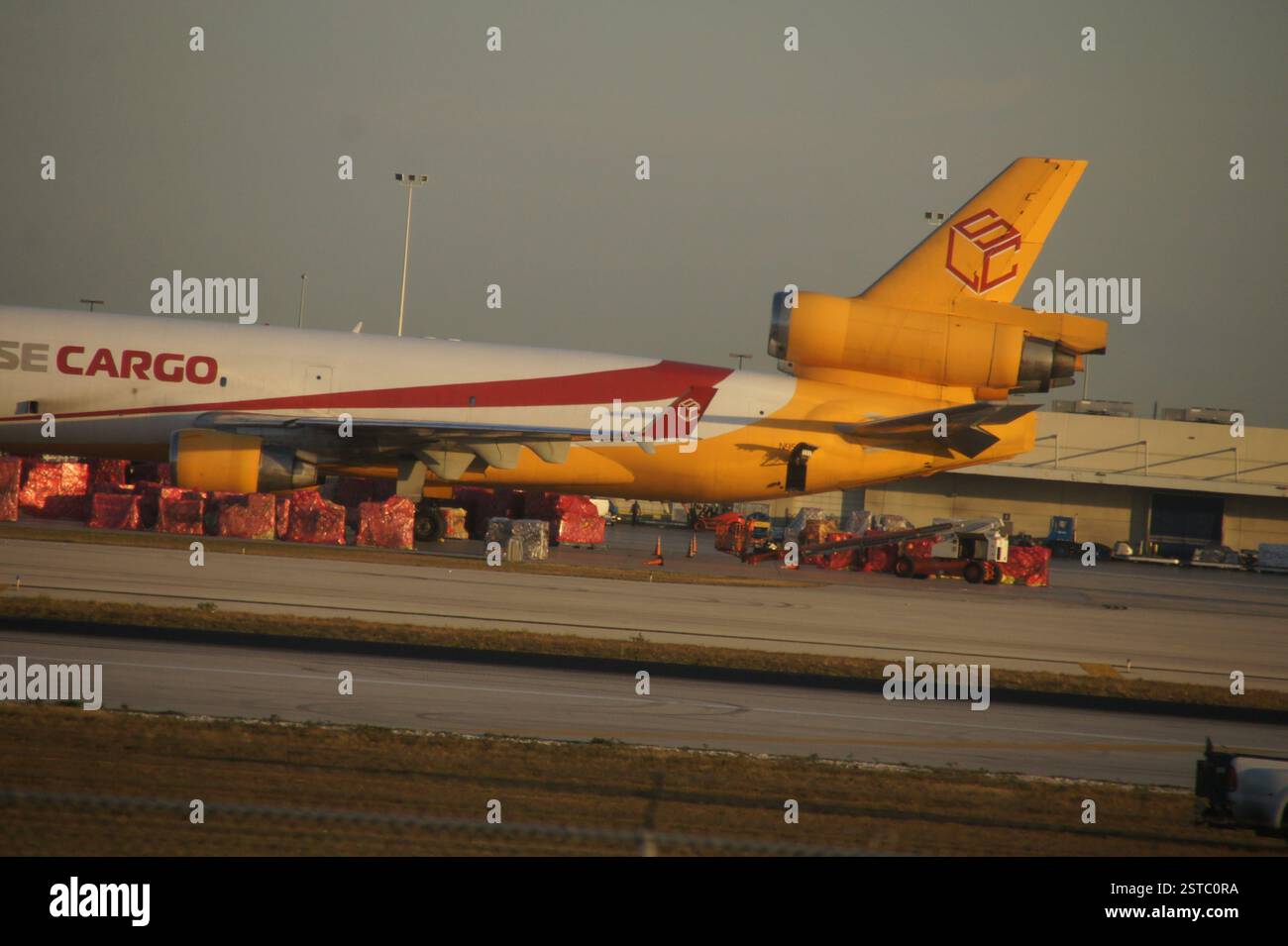 Cargo airplane parked Miami runway. Yellow tail section, McDonnell ...