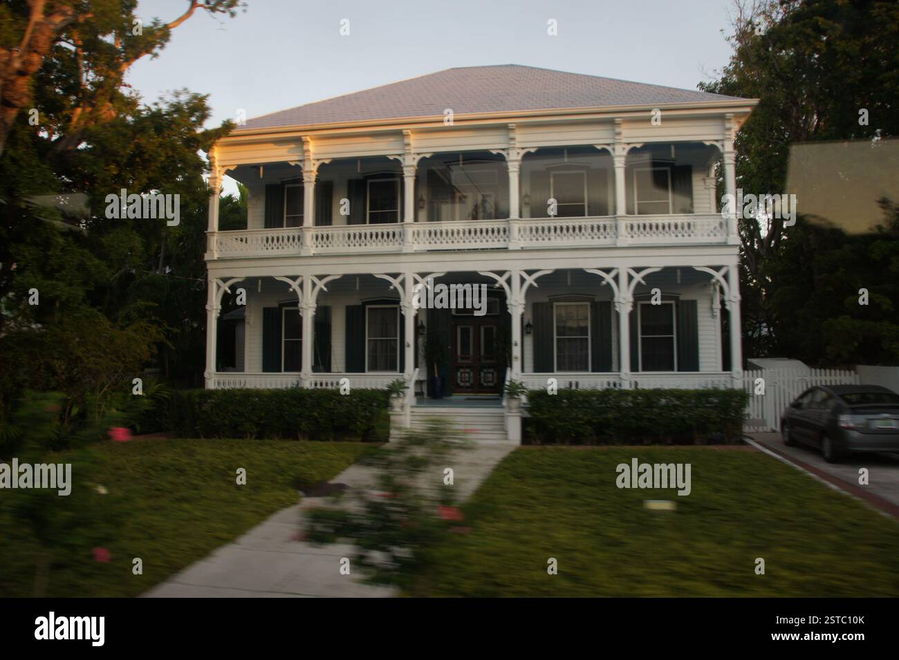 A white conch house with a car parked in front on Eaton Street, Key ...