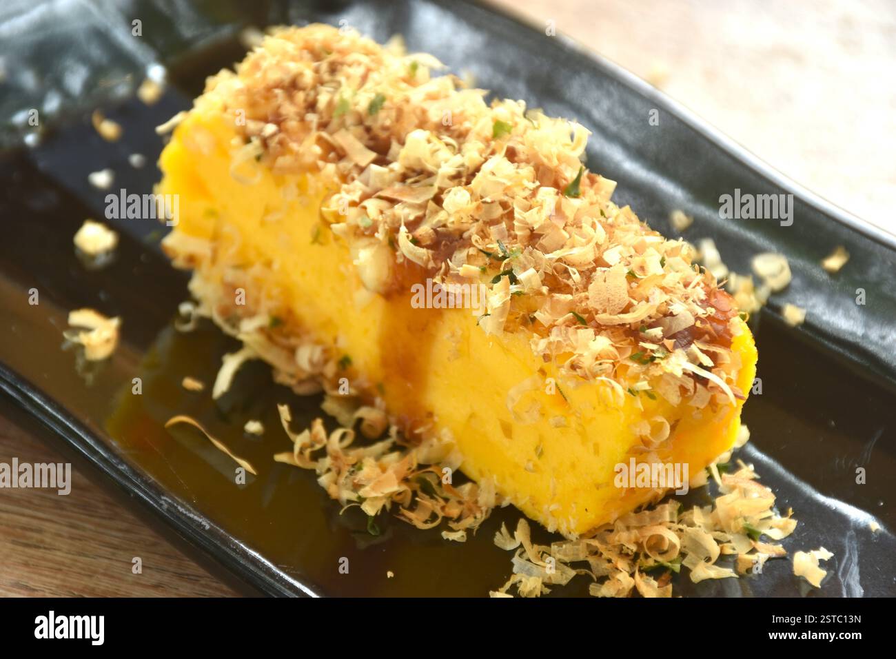 grilled Tamakoyaki or Japanese sweet egg roll omelet topping dry fish ...