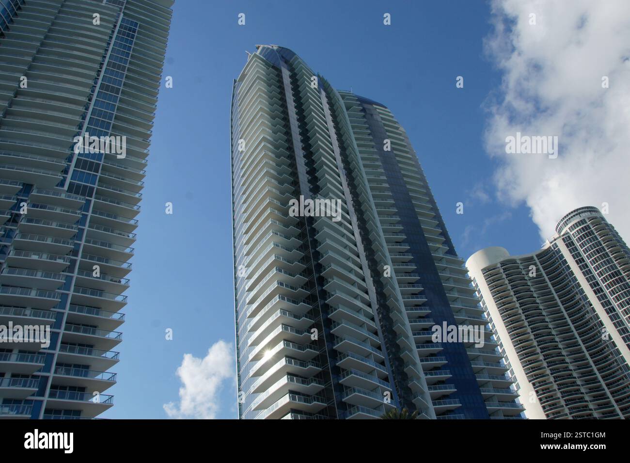 Miami skyline dominates the horizon. Towering glass structures reach ...