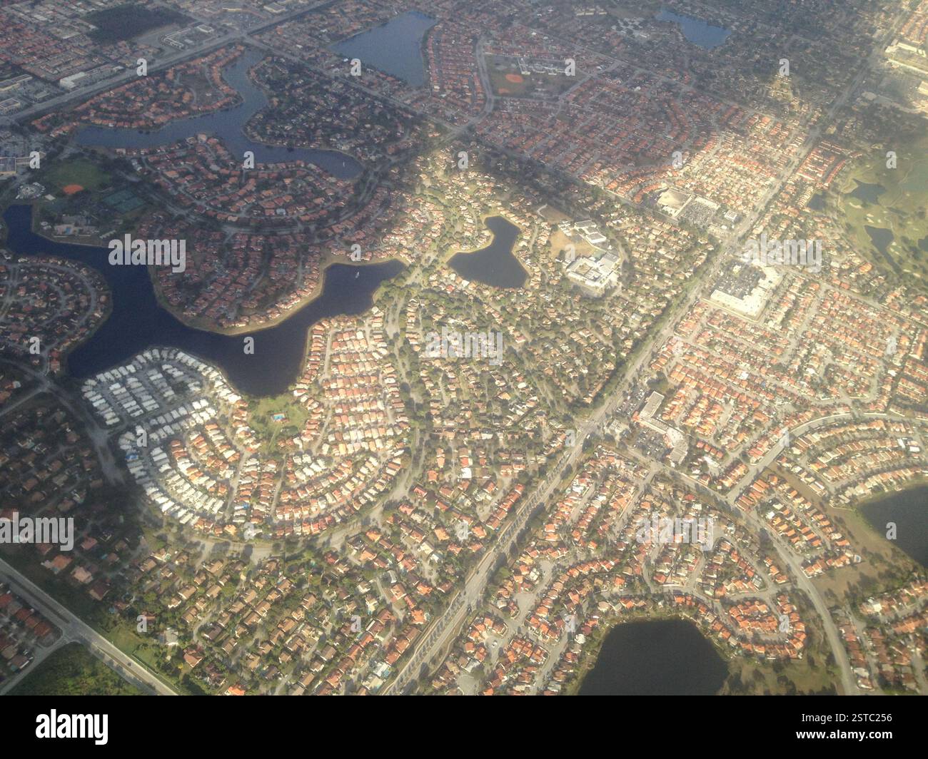 Aerial view of a suburban neighborhood Miami colorful houses winding ...