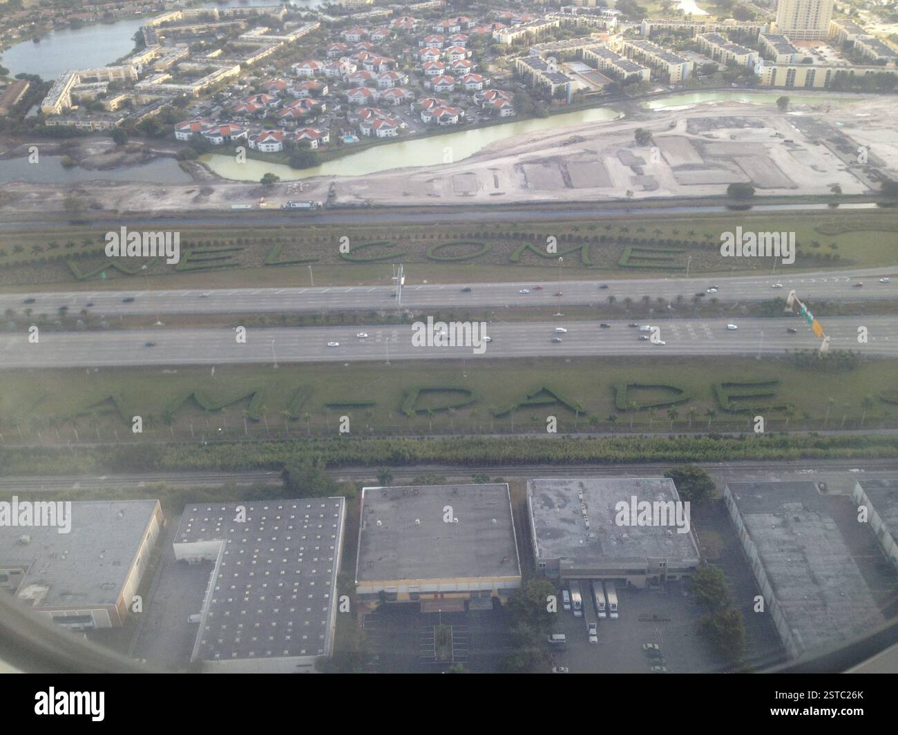 Aerial view Miami highway interchange lush green scenery. City skyline ...