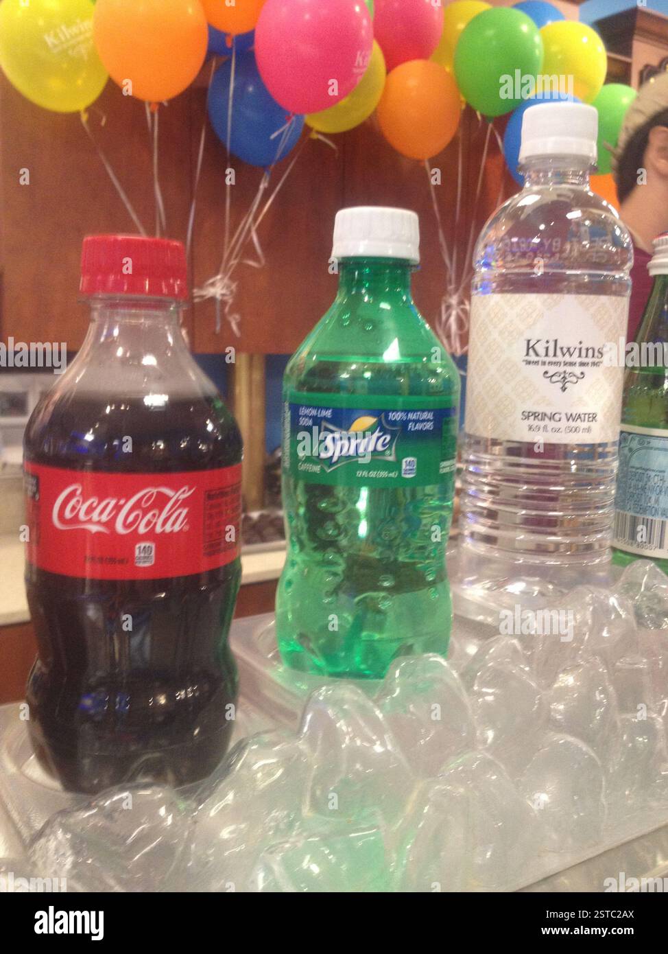 Three beverage bottles on ice Miami Kilwins background. Coca-Cola ...