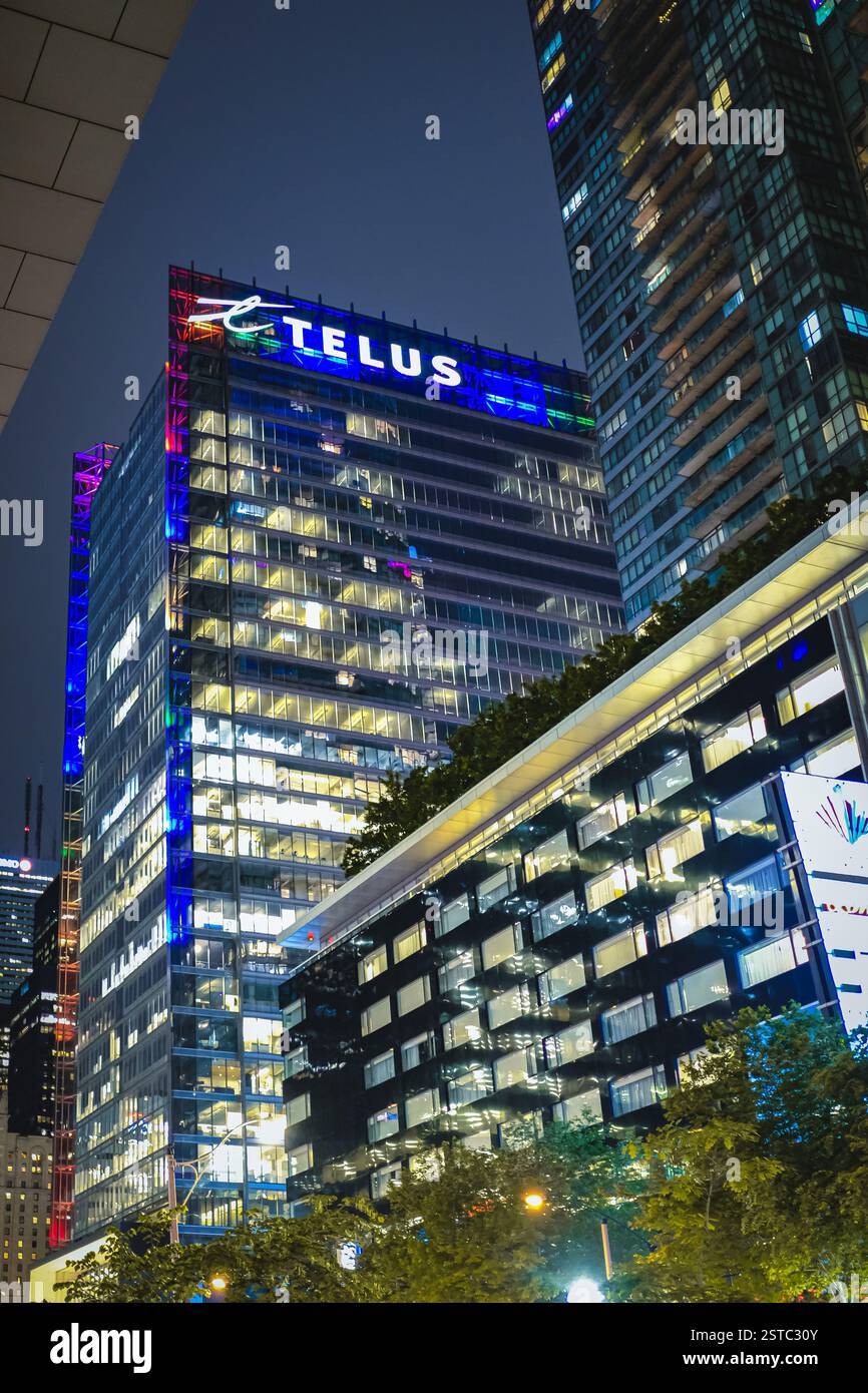 Financial District City Skyline Skyscrapers at night. Telus Telecommunications Company logo on a ...