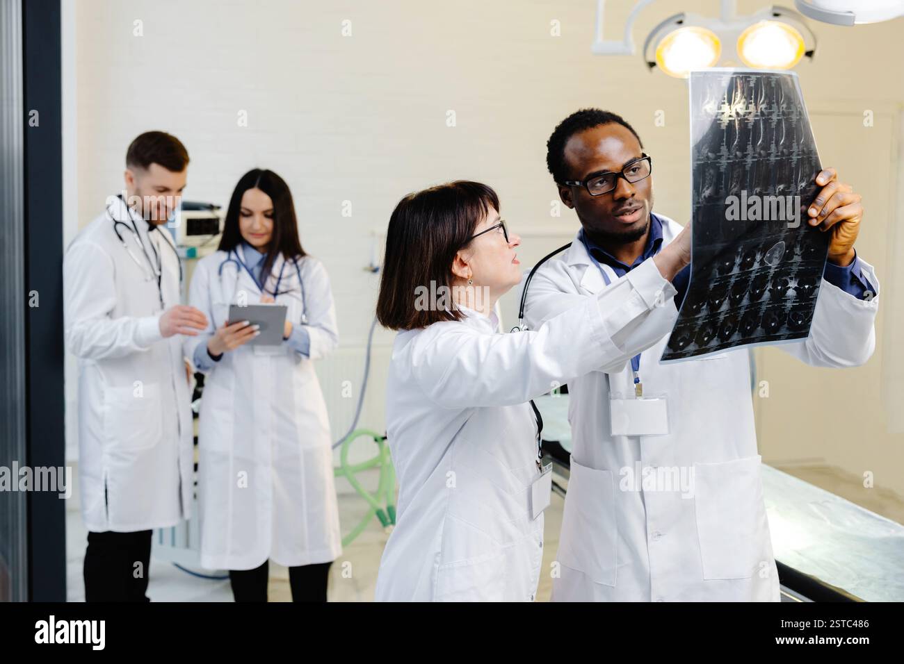 Group of scientists examining data on paper Stock Photo - Alamy