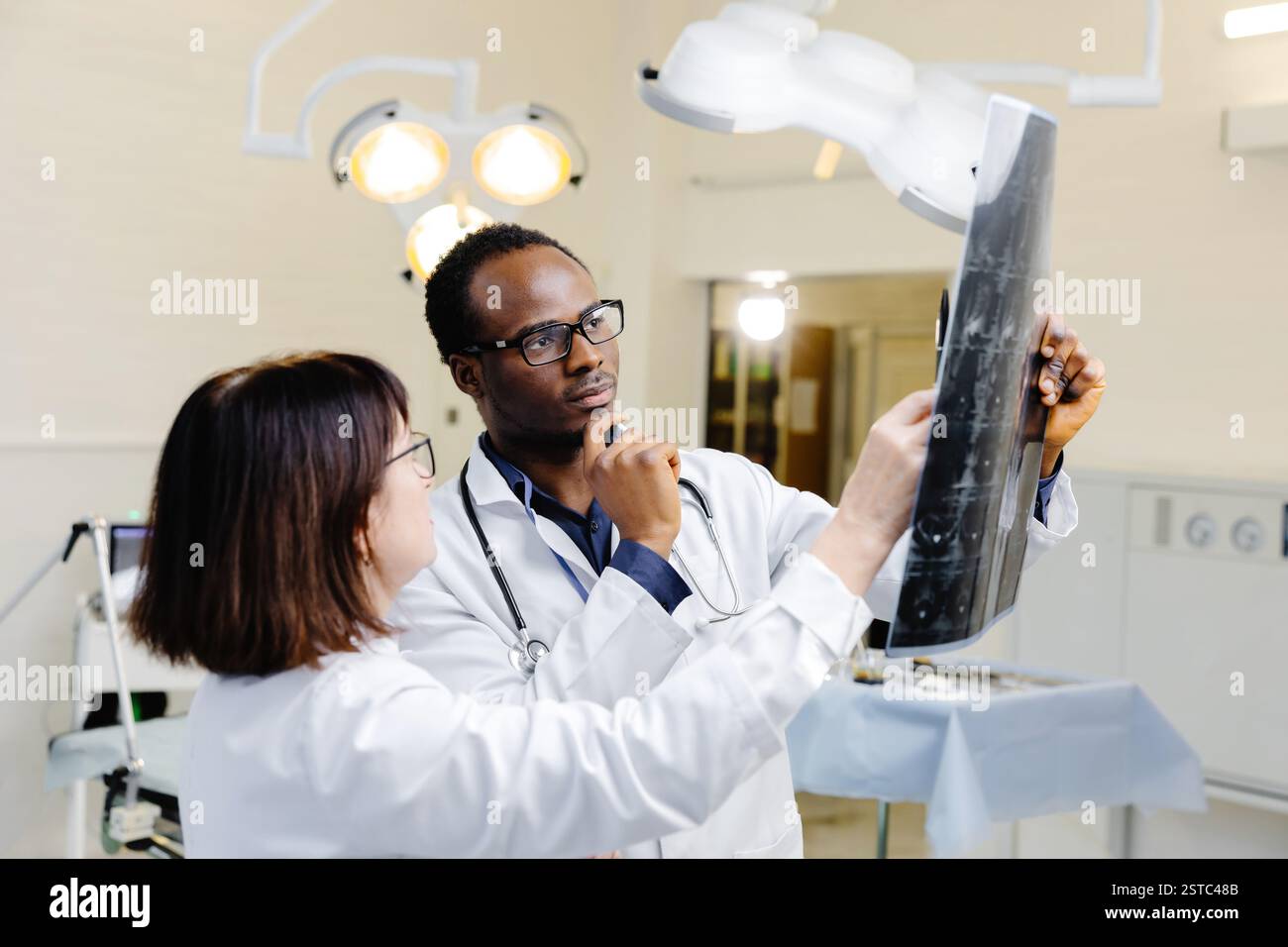 Man and woman in white lab coats conducting experiment Stock Photo - Alamy