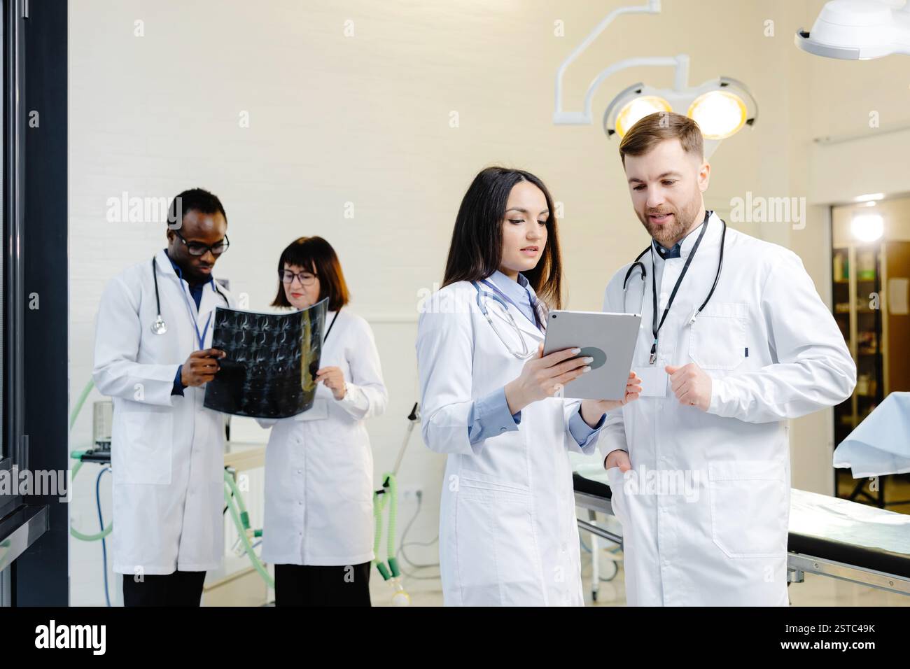 Group of scientists examining data on paper Stock Photo - Alamy