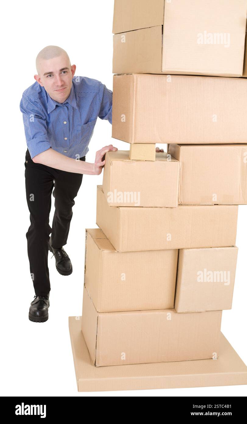 Man pushing heap from cardboard boxes Stock Photo - Alamy
