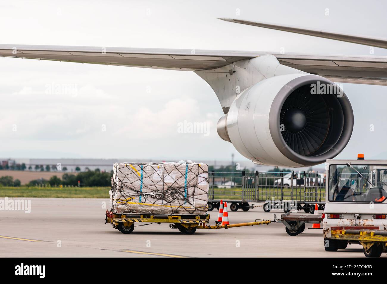 Preparation freight airplane at airport. Loading of cargo containers to ...