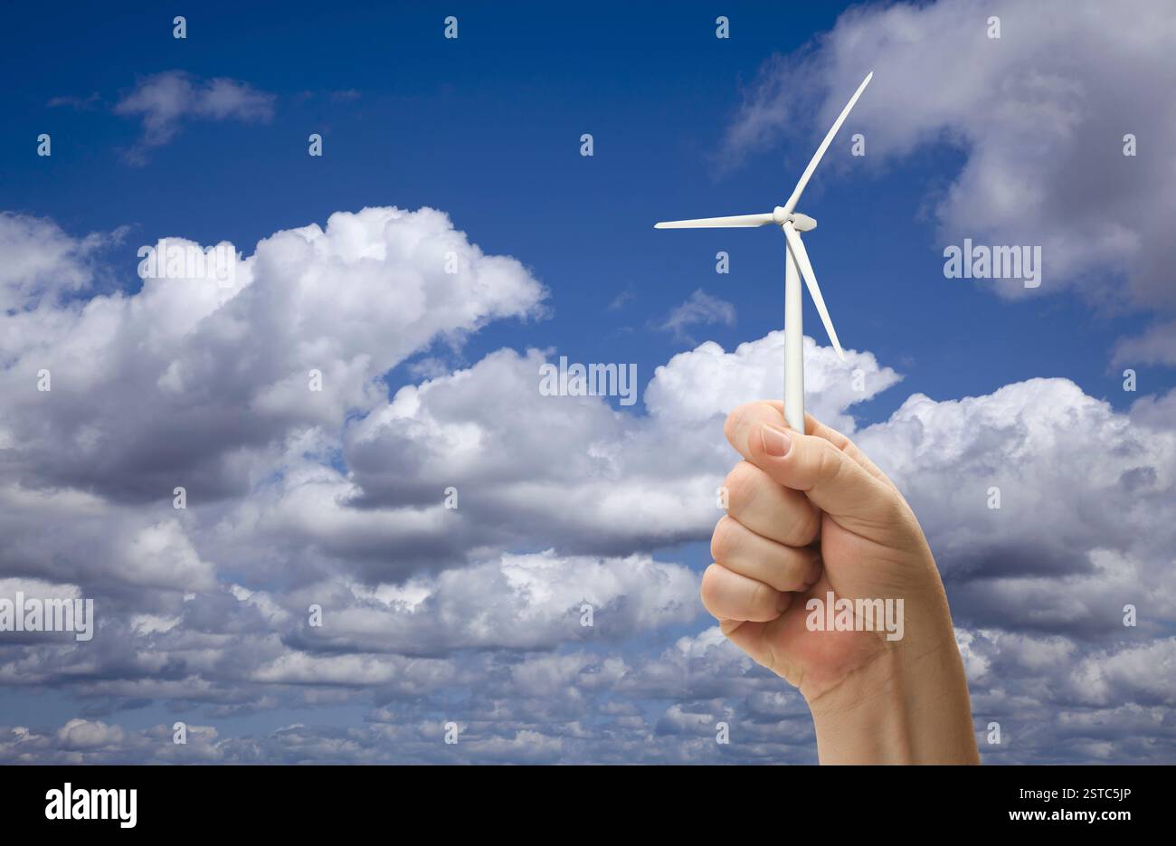 Male Fist Holding Wind Turbine Outside Stock Photo - Alamy