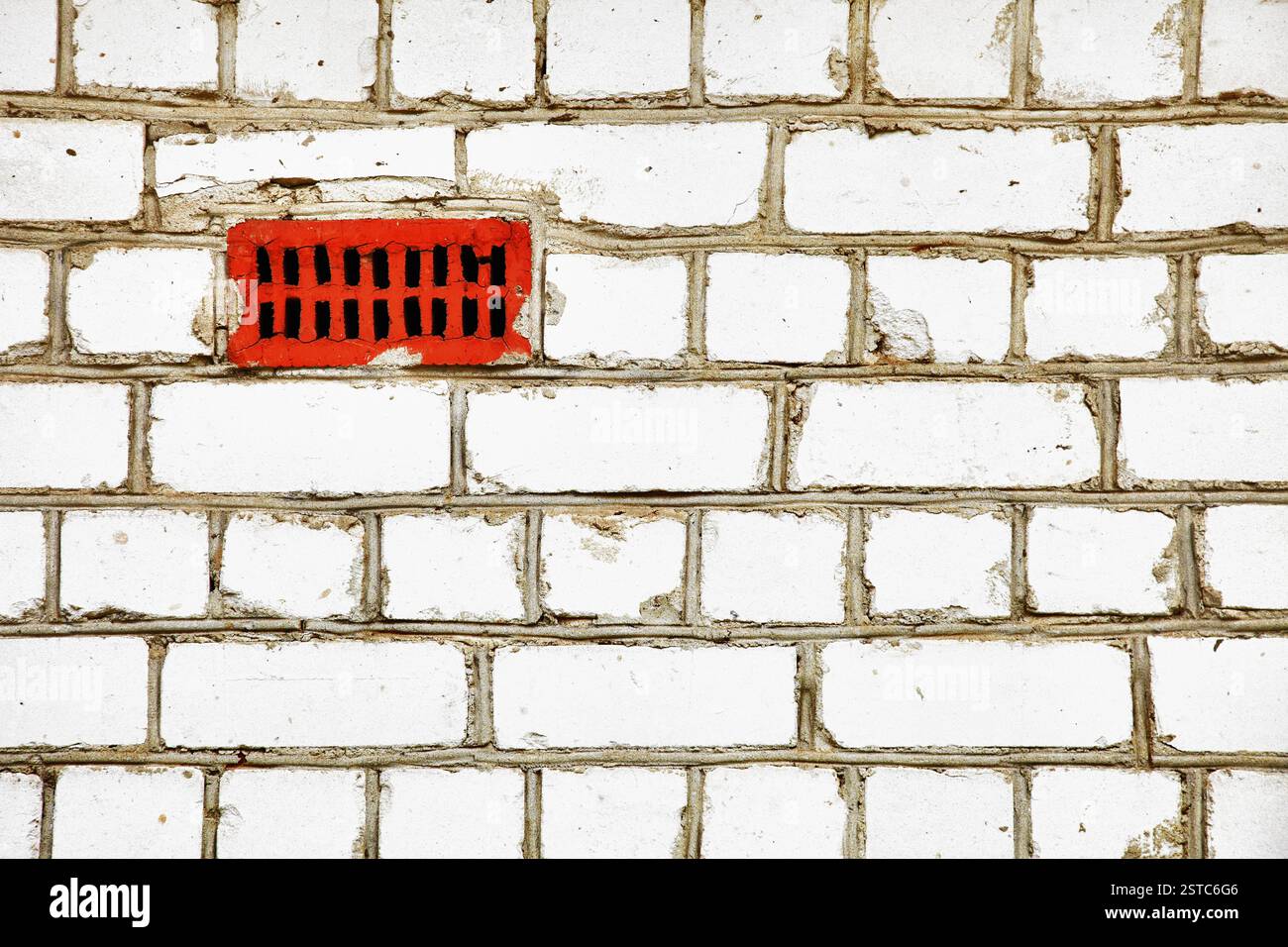 Improvised ventilation in gray primitive brick wall Stock Photo - Alamy