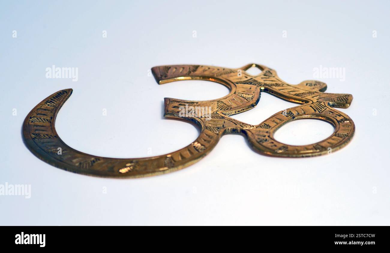 OM (aum) sign made of brass isolated on white background Stock Photo ...