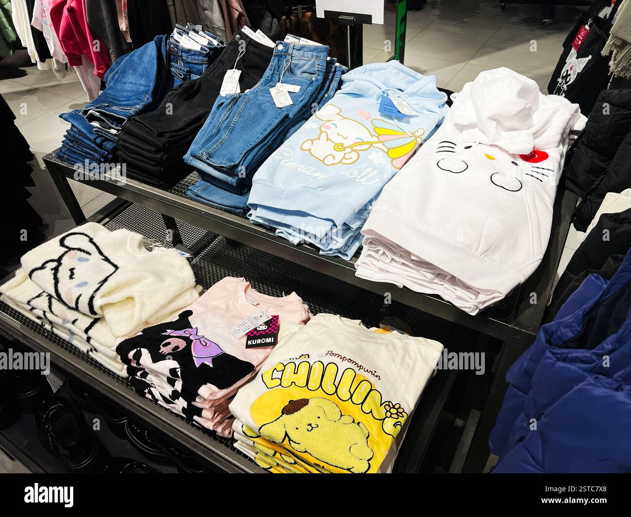 Lviv, Ukraine - February 16, 2025: Stacked clothing items featuring character-themed designs ...