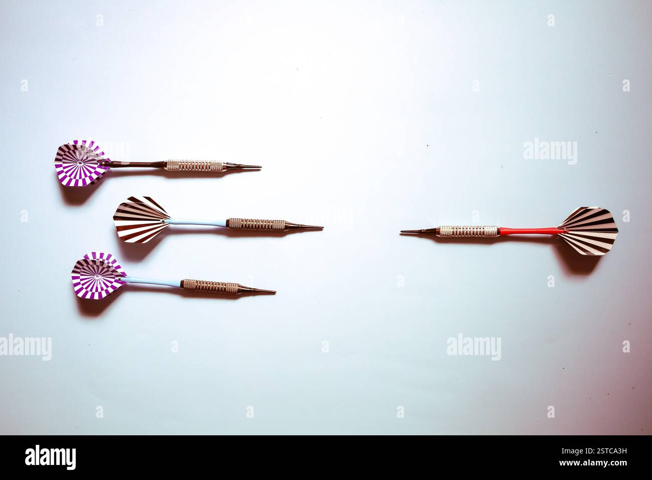 More darts against one dart as a conceputal photo of unfair forces on a ...