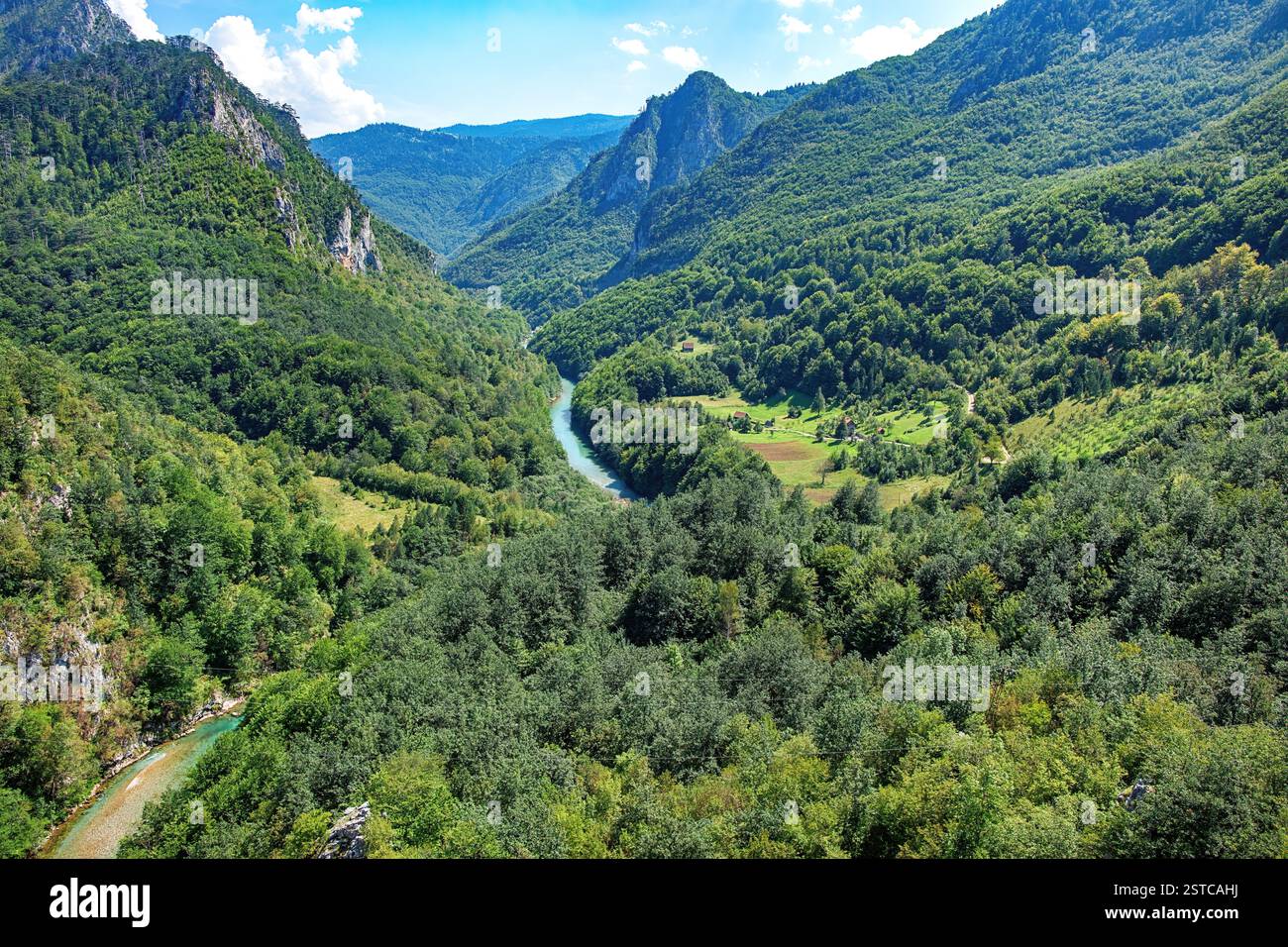 Breathtaking view of a river winding through lush green valleys in a ...