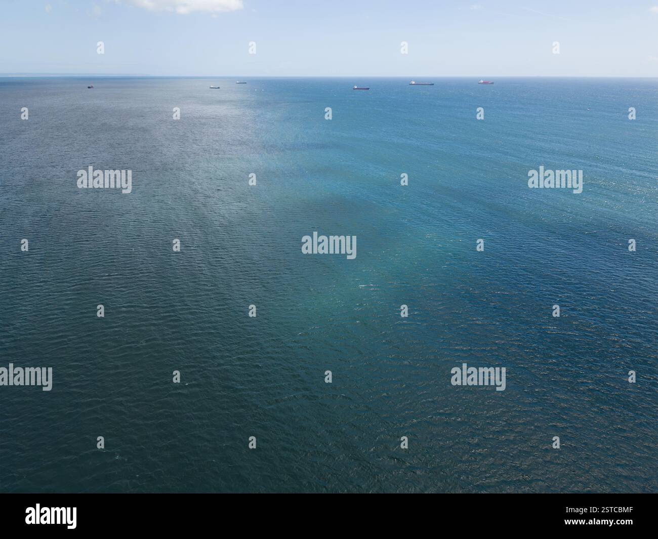 Aerial view of the ocean with cargo ships on the horizon and a visible halocline Stock Photo - Alamy