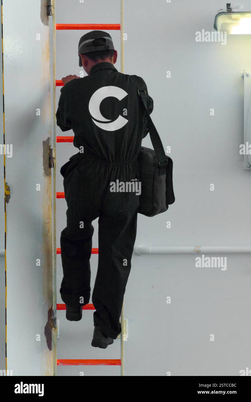 Civitavecchia, Italy - February 18, 2025: A Costa Cruises worker climbs ...