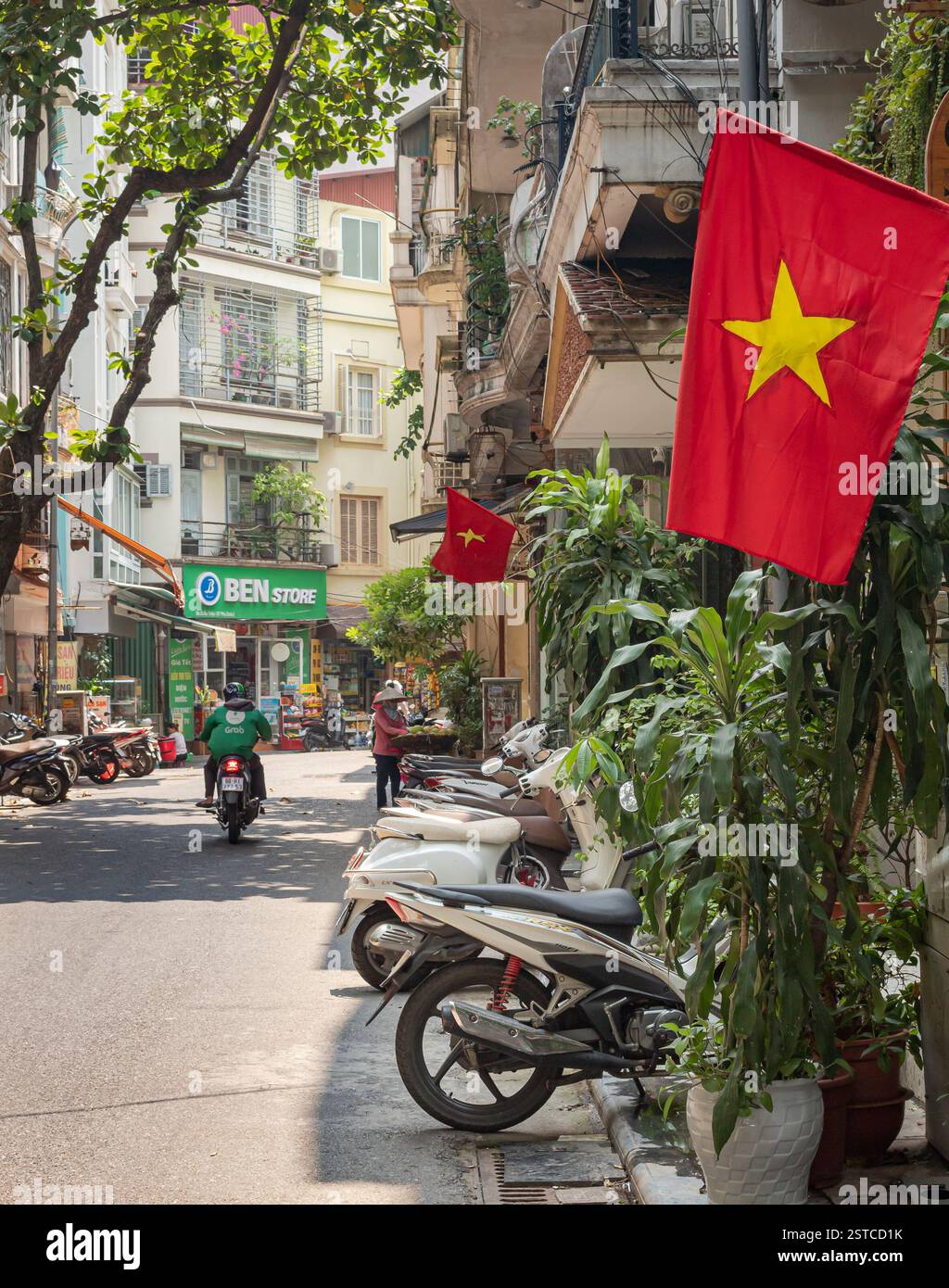 Red Vietnam flag, streets, alleys and motorcycles in Hanoi Vietnam ...