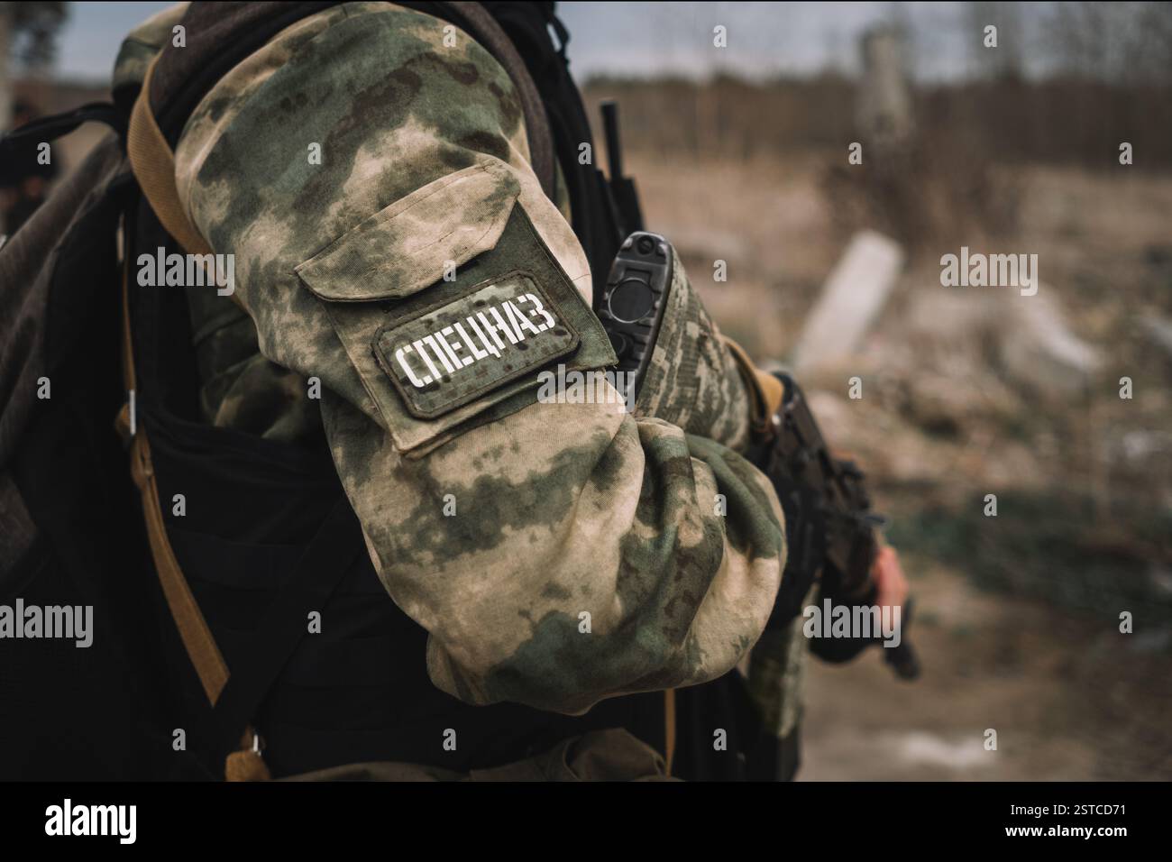 A special forces soldier with a machine gun in close-up. translation of the inscription on the ...