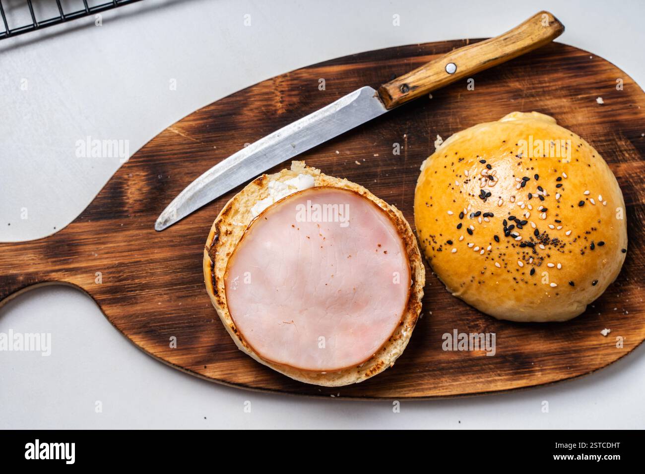 Sesame Bun Cut to Make Ham and Cheese Sandwich on Wooden Cutting Board ...