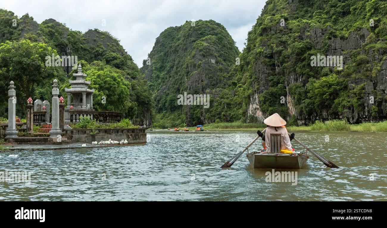 People on a boat floating down a river surrounded by tropical lush ...