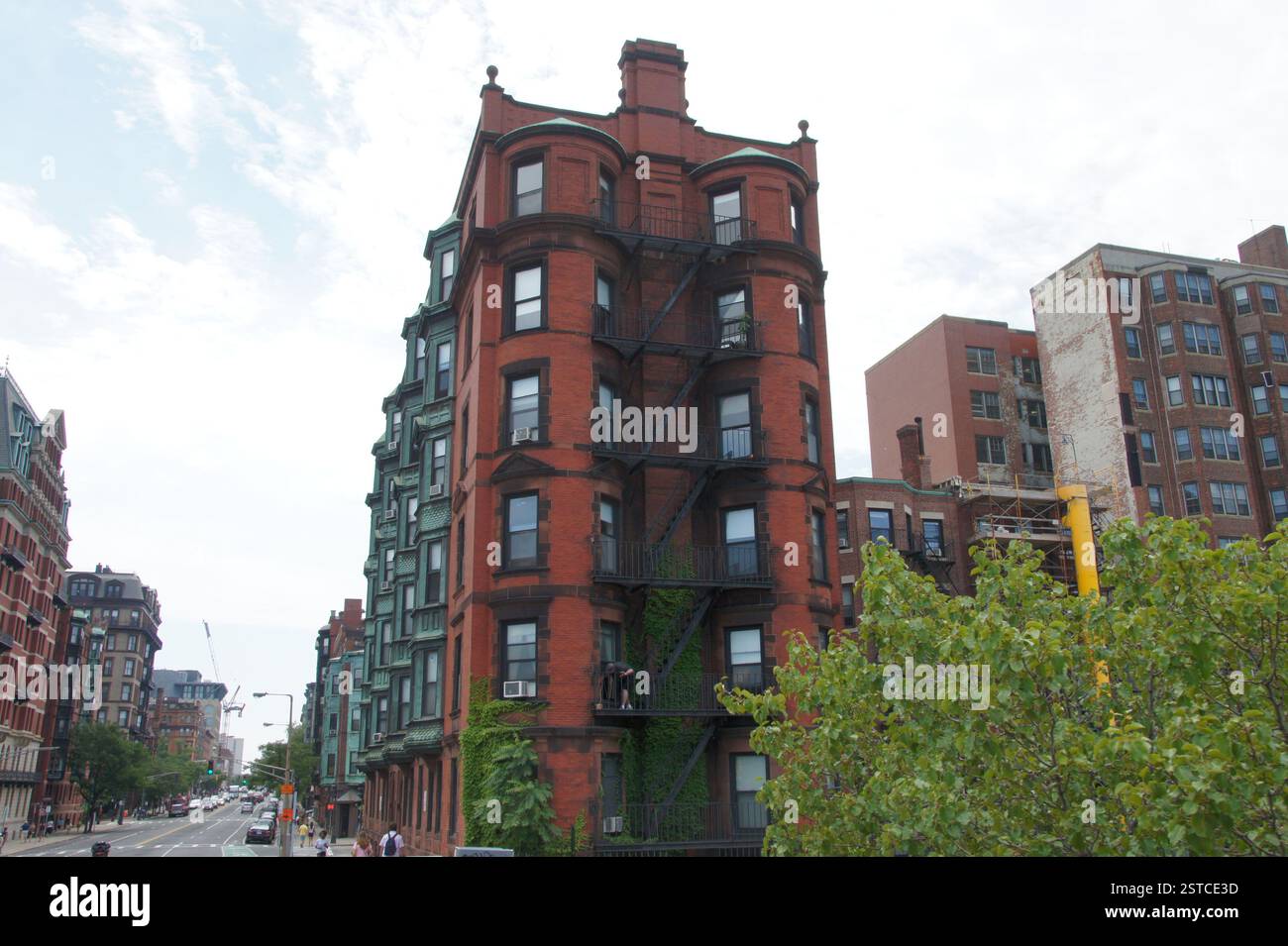Boston brownstone row. Brick facade, multiple windows, fire escape ...