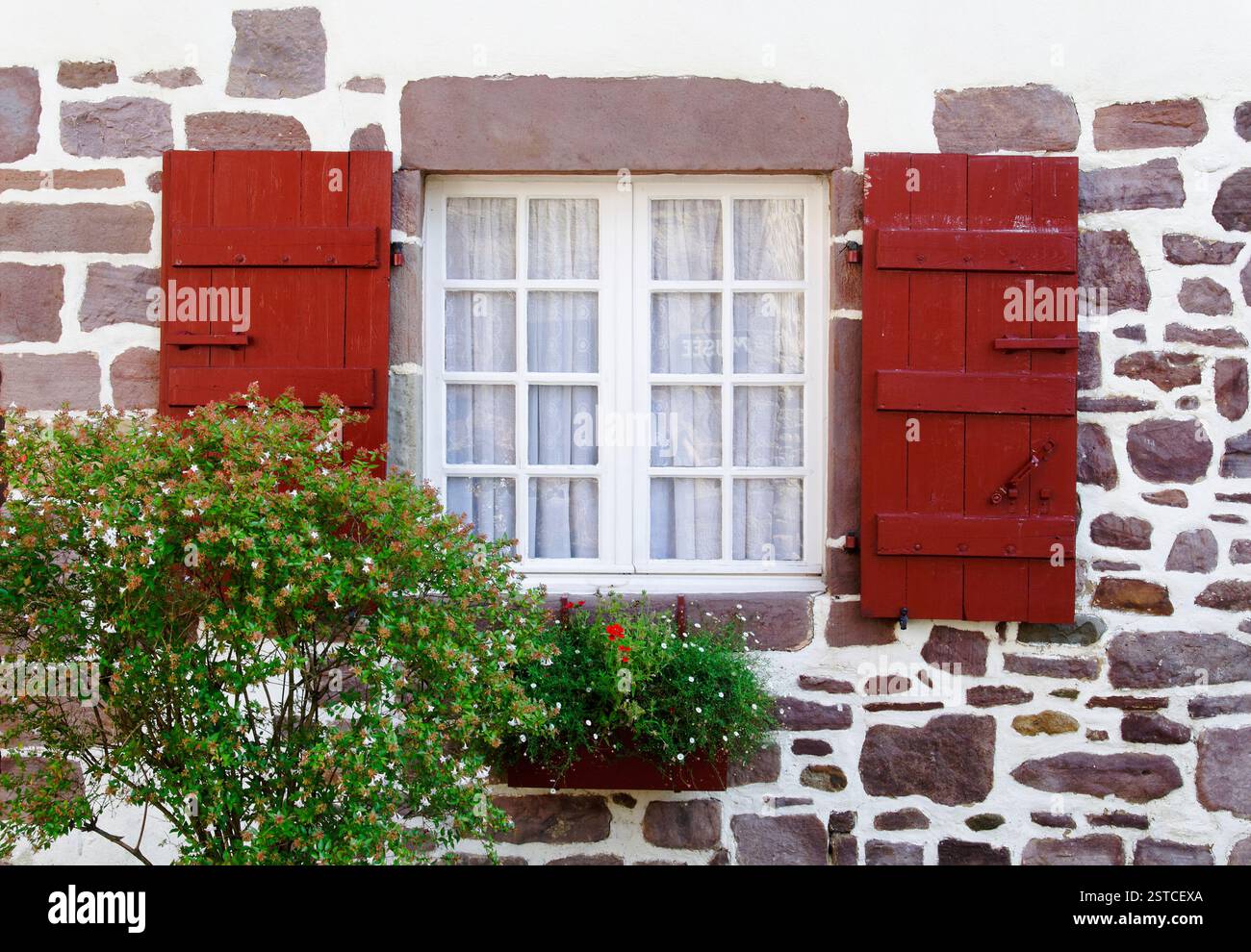 Typical Basque house: stone wall, white window and red shutters Stock ...