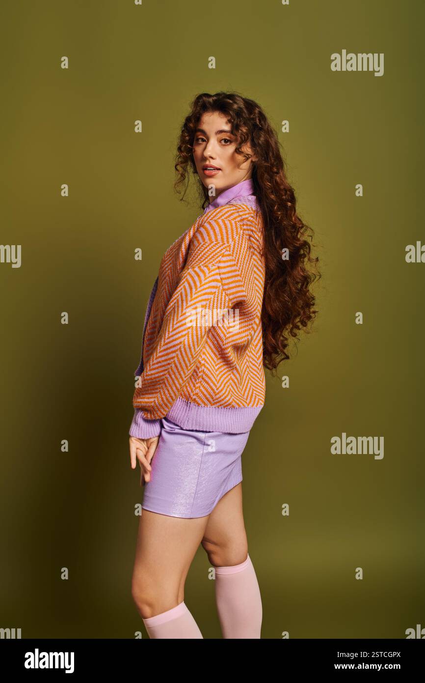 A young woman flaunts her unique style in a colorful outfit, striking a ...