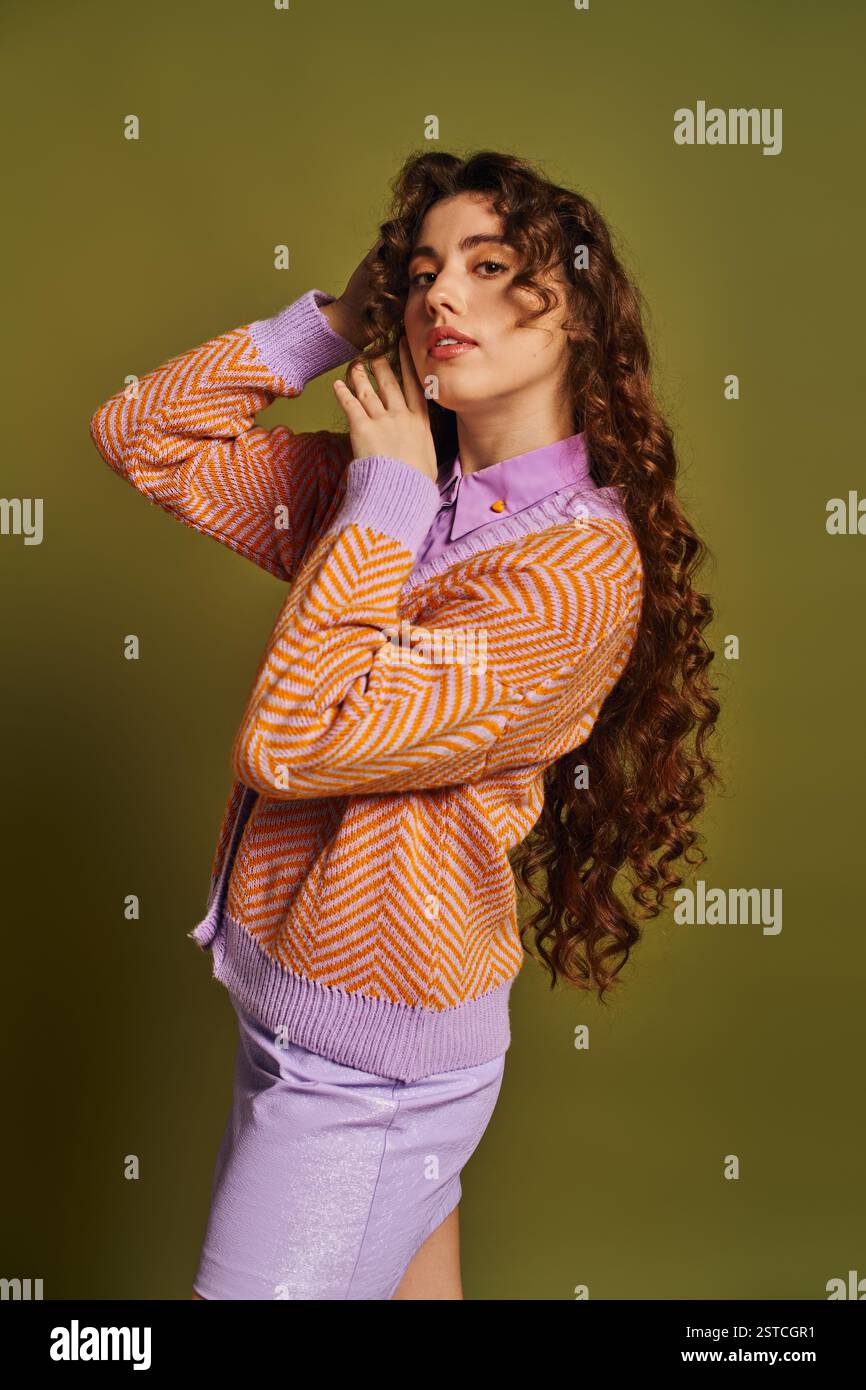 Elegant woman poses confidently wearing chic attire against a colorful ...