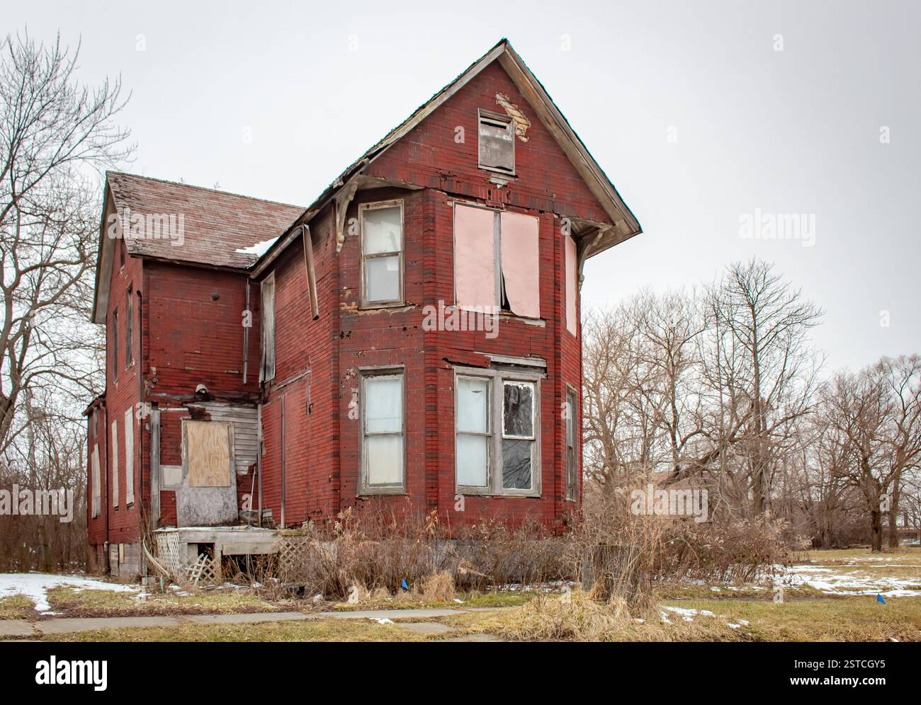 Old abandoned boarded up house in Detroit Michigan on a cloudy day ...