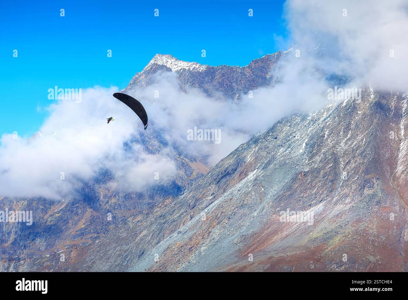 Paraglider over mountain snow peaks, Swiss Alps, Zermatt, Switzerland ...