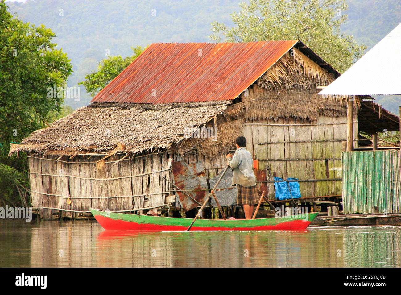 Local man rowing through water village hi-res stock photography and ...