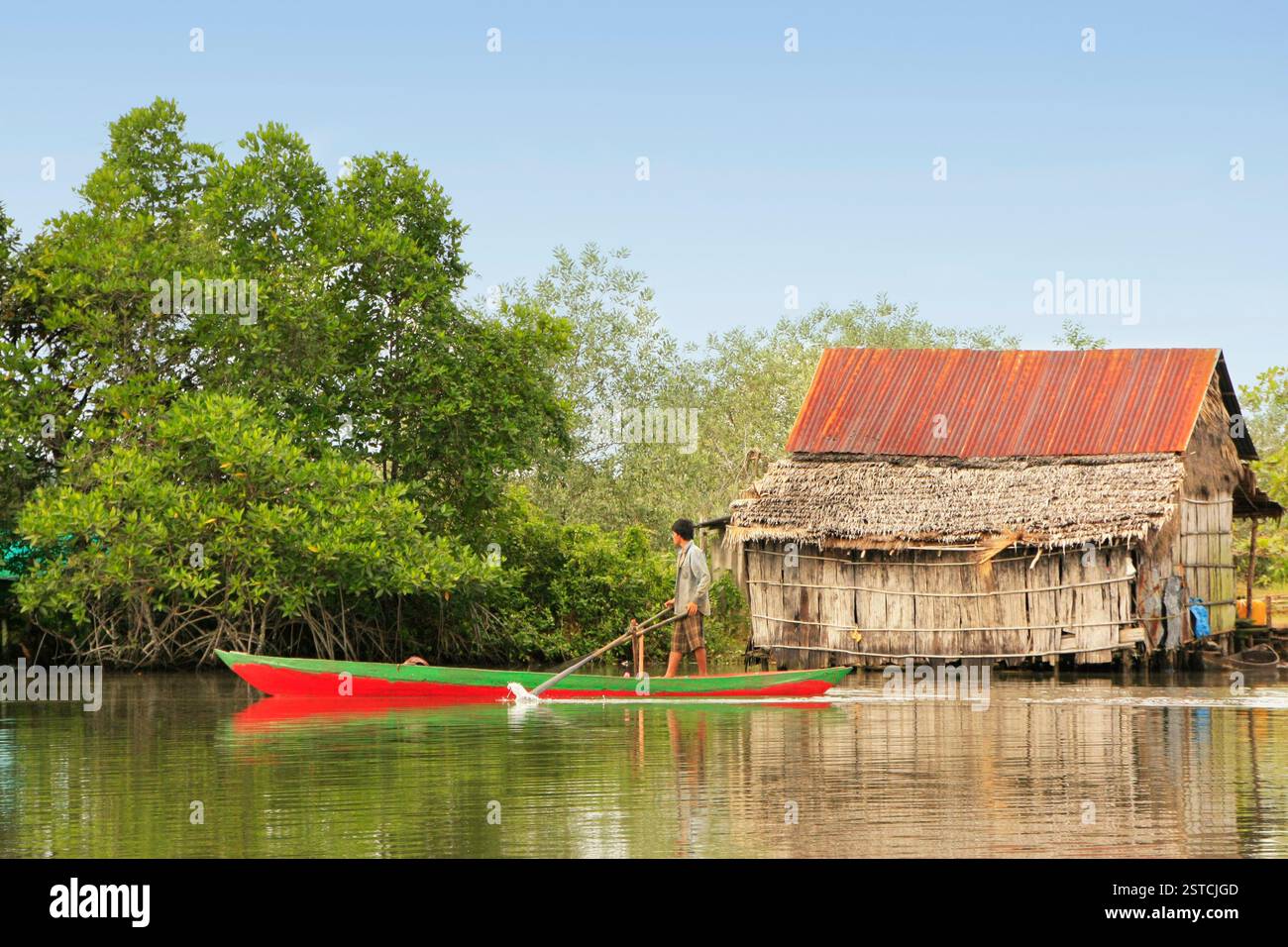 Local man rowing through water village, Ream Natio Stock Photo - Alamy