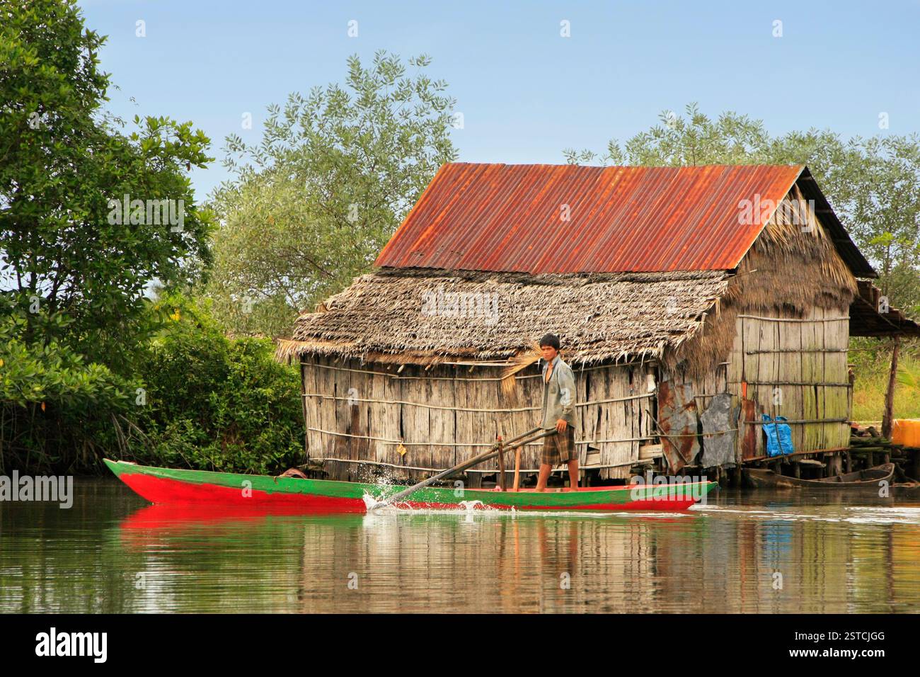 Local man rowing through water village, Ream Natio Stock Photo - Alamy