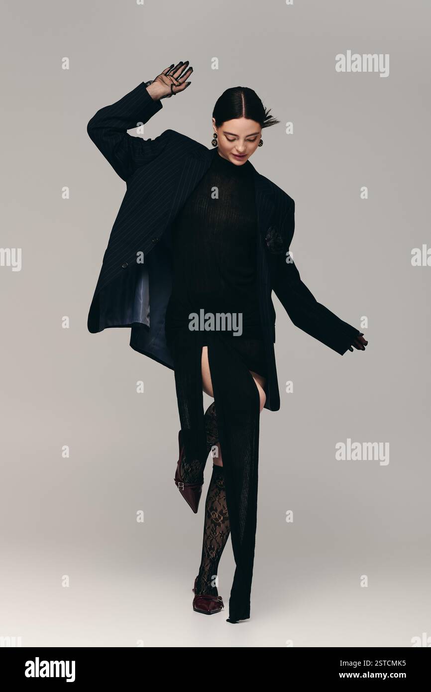 A young and fashionable woman strikes a playful pose while exploring ...