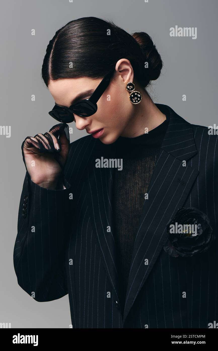 A stylish young woman in a tailored black suit exudes confidence and ...