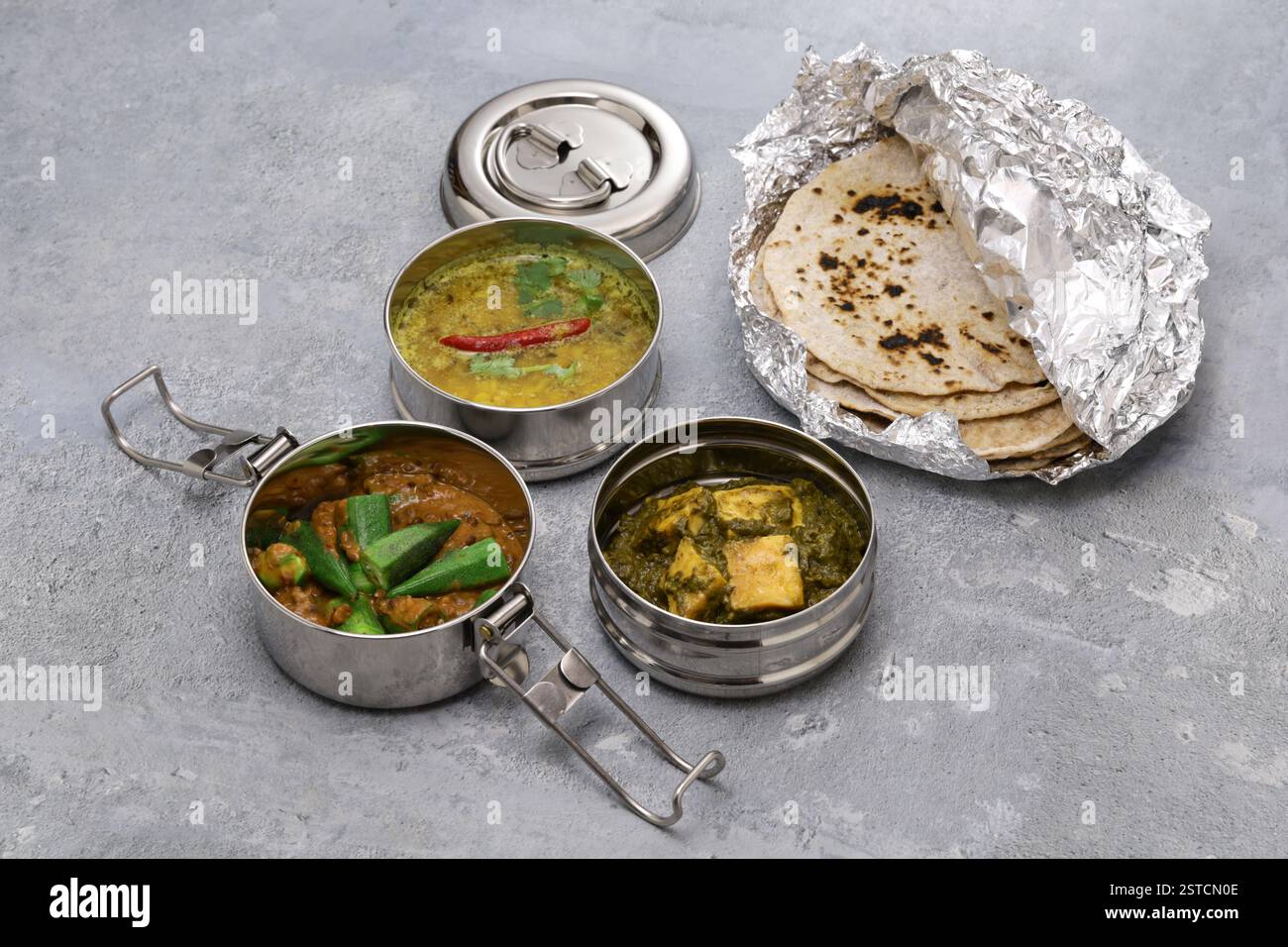 A retro Indian lunch box filled with vegetarian food. And chapati Stock ...