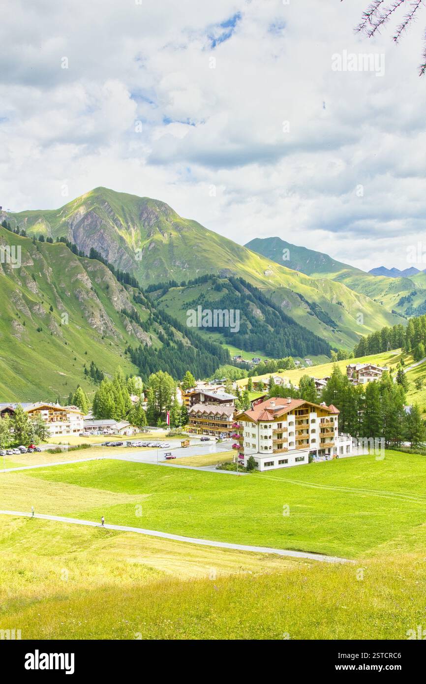 Scenic alpine village of Samnaun, Switzerland, surrounded by lush green ...