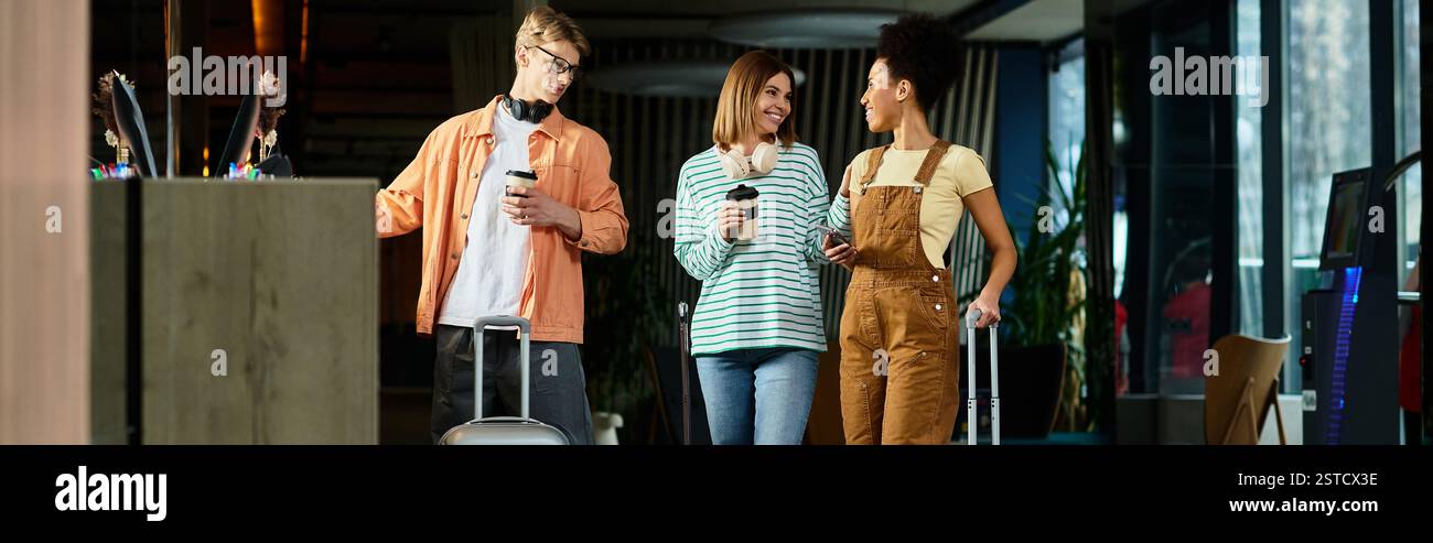 Three colleagues chat and laugh together in a hotel lobby, enjoying a ...