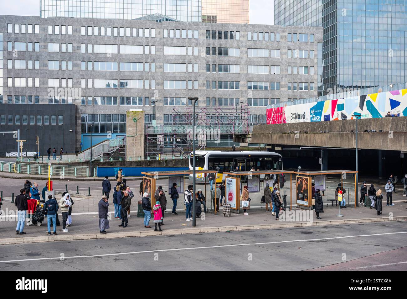 People waiting at the main bus stop of the Brussels North railway ...