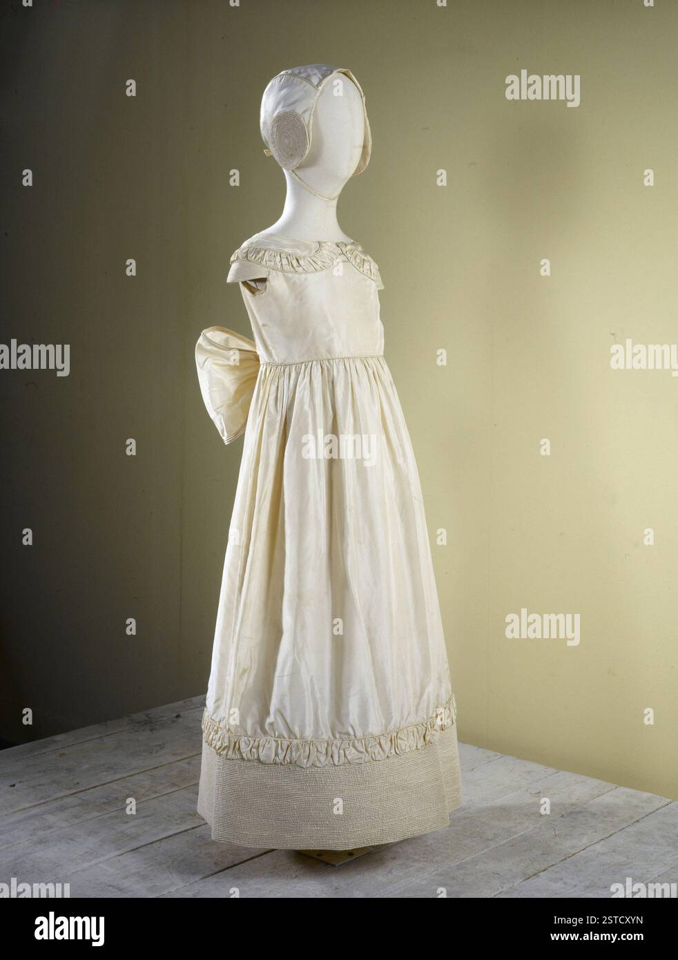 A fashion illustration featuring a dress with a large flat knot at the ...