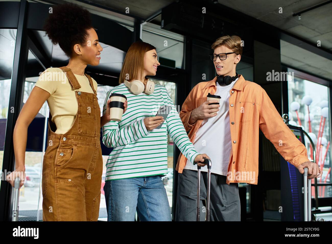Three colleagues engage in conversation while waiting in the hotel ...