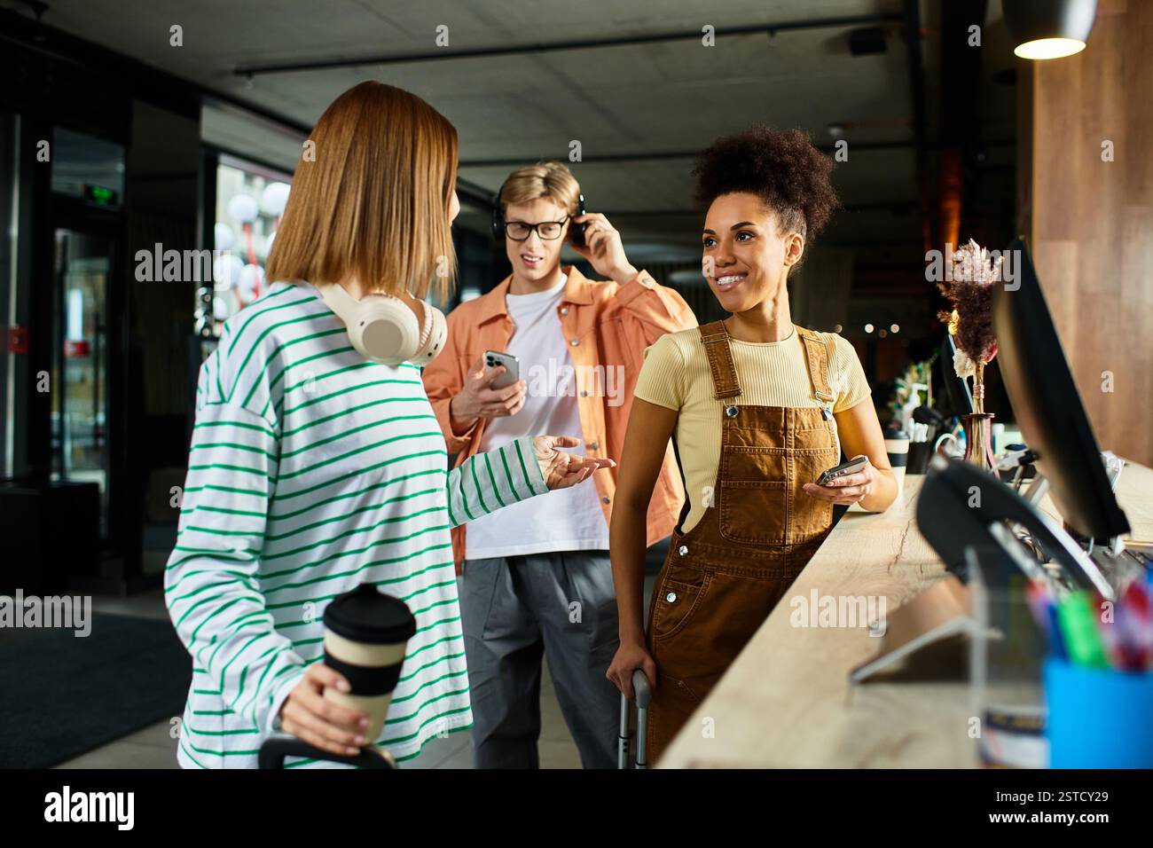 Two colleagues enjoy a friendly conversation while one checks in at the ...