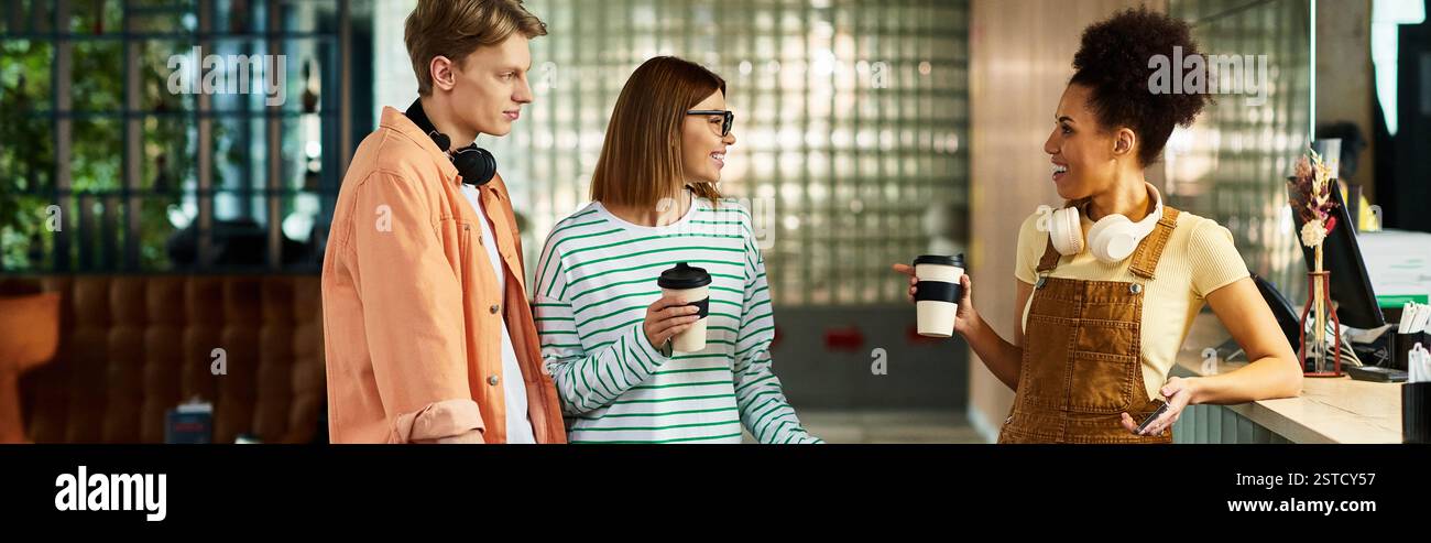 Three colleagues engage in a lively conversation over coffee at a ...
