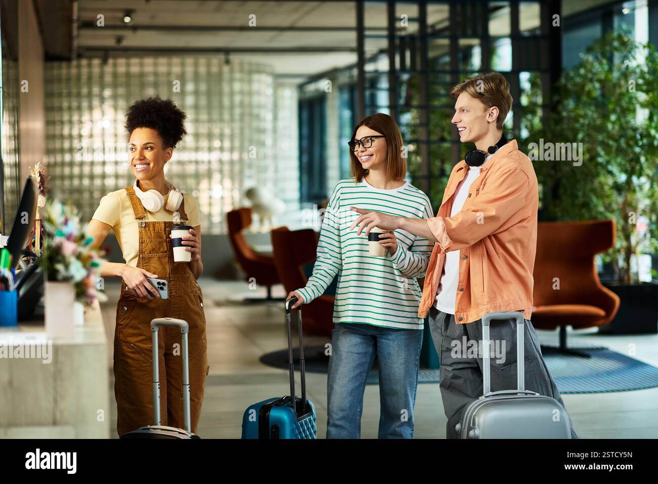 Three colleagues enjoy a friendly moment as they check into a hotel for ...